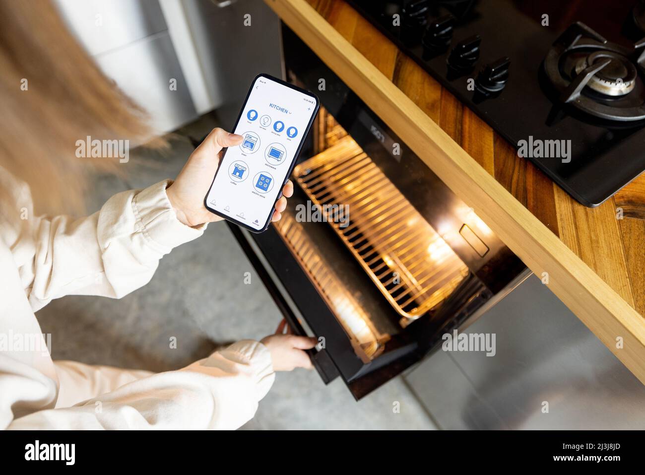 Controlling kitchen appliances with a smart phone Stock Photo - Alamy
