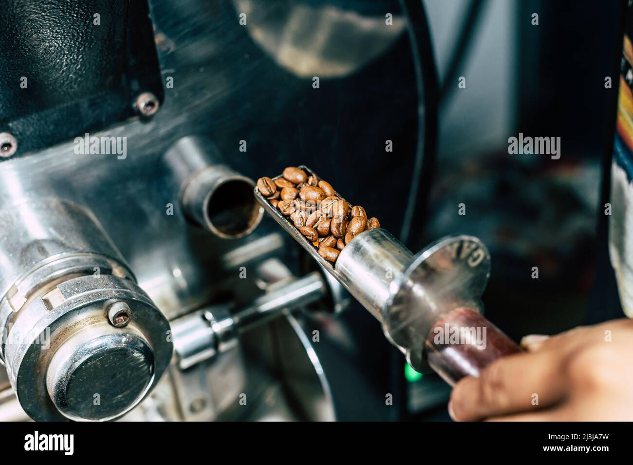 Coffee roaster machine at coffee roasting process. Mixing coffee beans ...