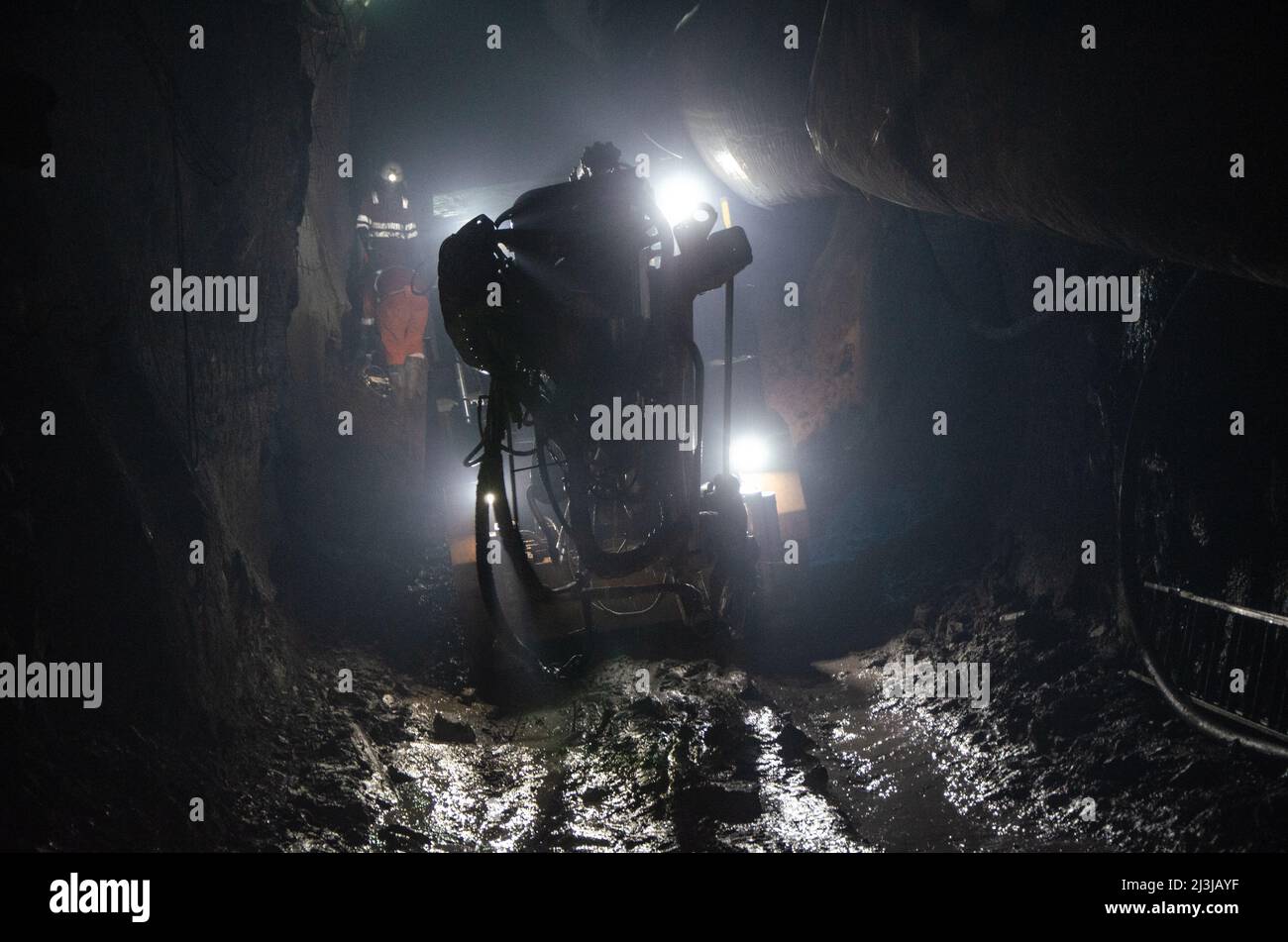 Mining operator on mining machine, underground mine mesh Stock Photo ...