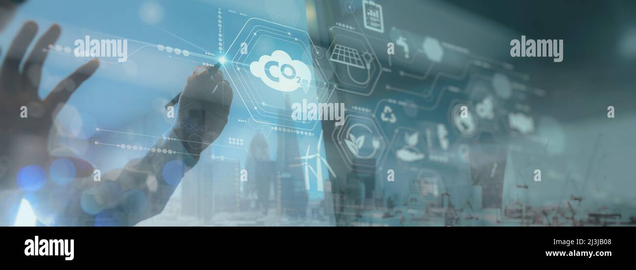 Businessman working virtual modern computer to reduce CO2 emissions ...