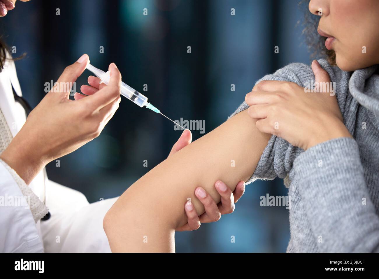 Itll only hurt for a few seconds. Shot of a woman receiving an ...