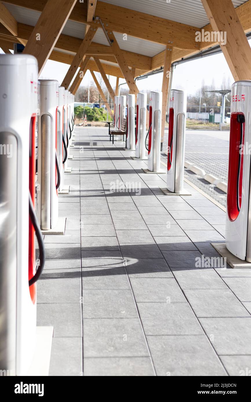 Charging columns at a Tesla Supercharger station in Germany Stock Photo ...
