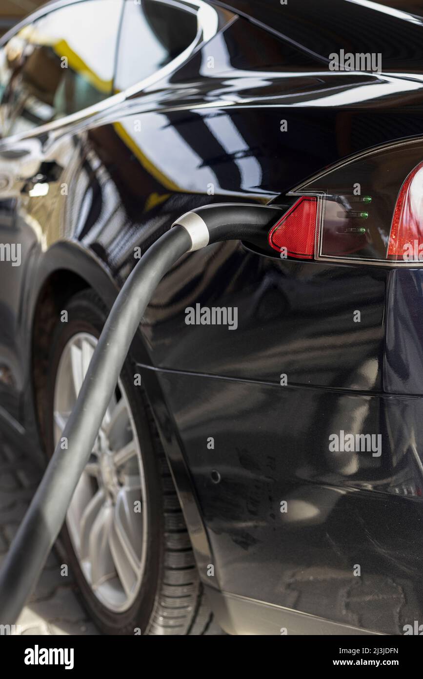 Rear view of tesla charging at charging station in germany hi-res stock ...