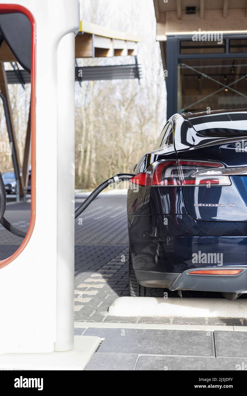 Tesla at the charging point of a Supercharger station in Germany Stock ...