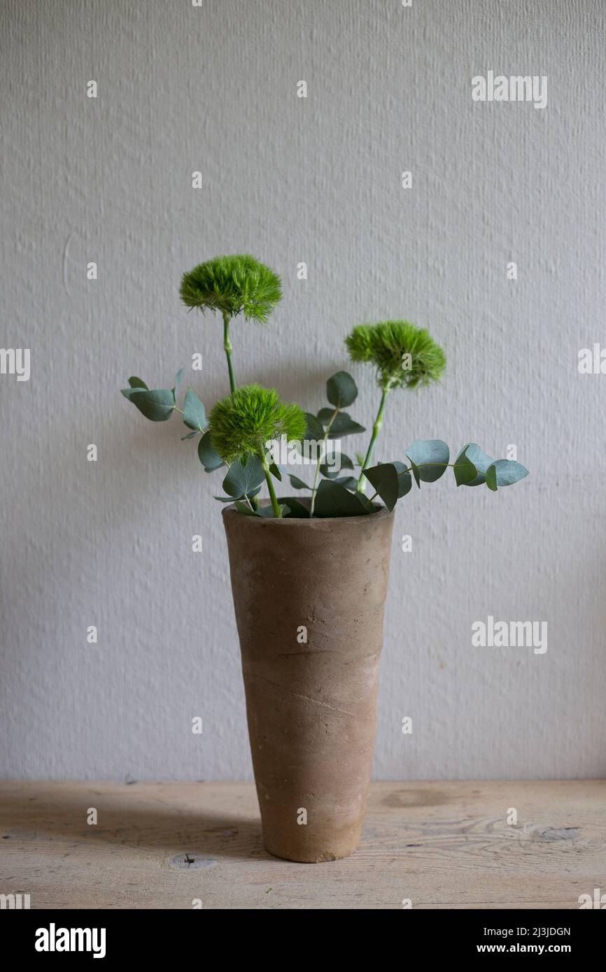 Stone vase with a modern bouquet of flowers Stock Photo - Alamy
