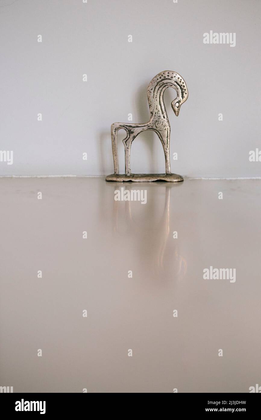 Small metal sculpture on a polished stone slab Stock Photo - Alamy