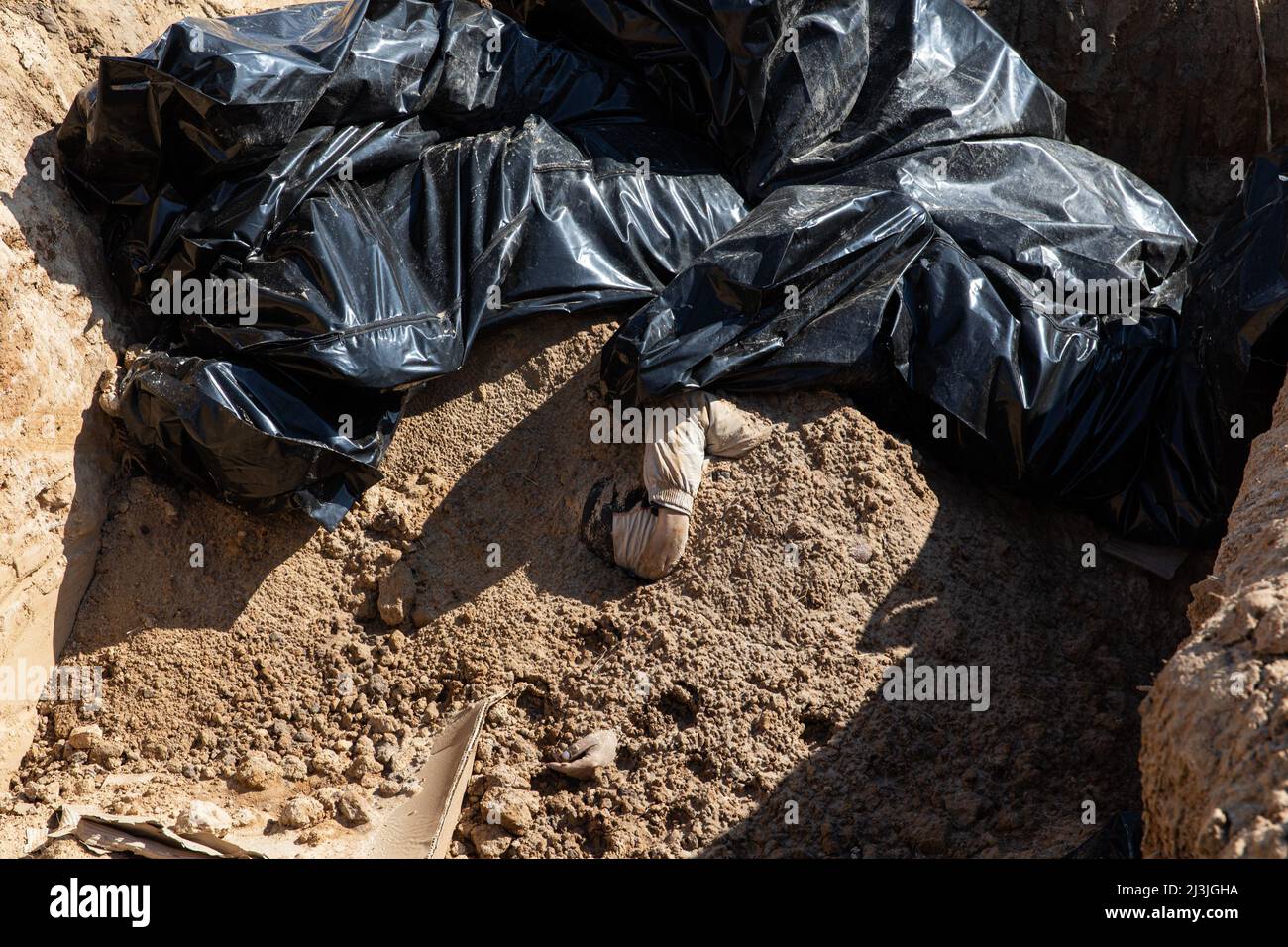 (EDITOR'S NOTE: Image depicts death) A corpse seen in the massive grave ...
