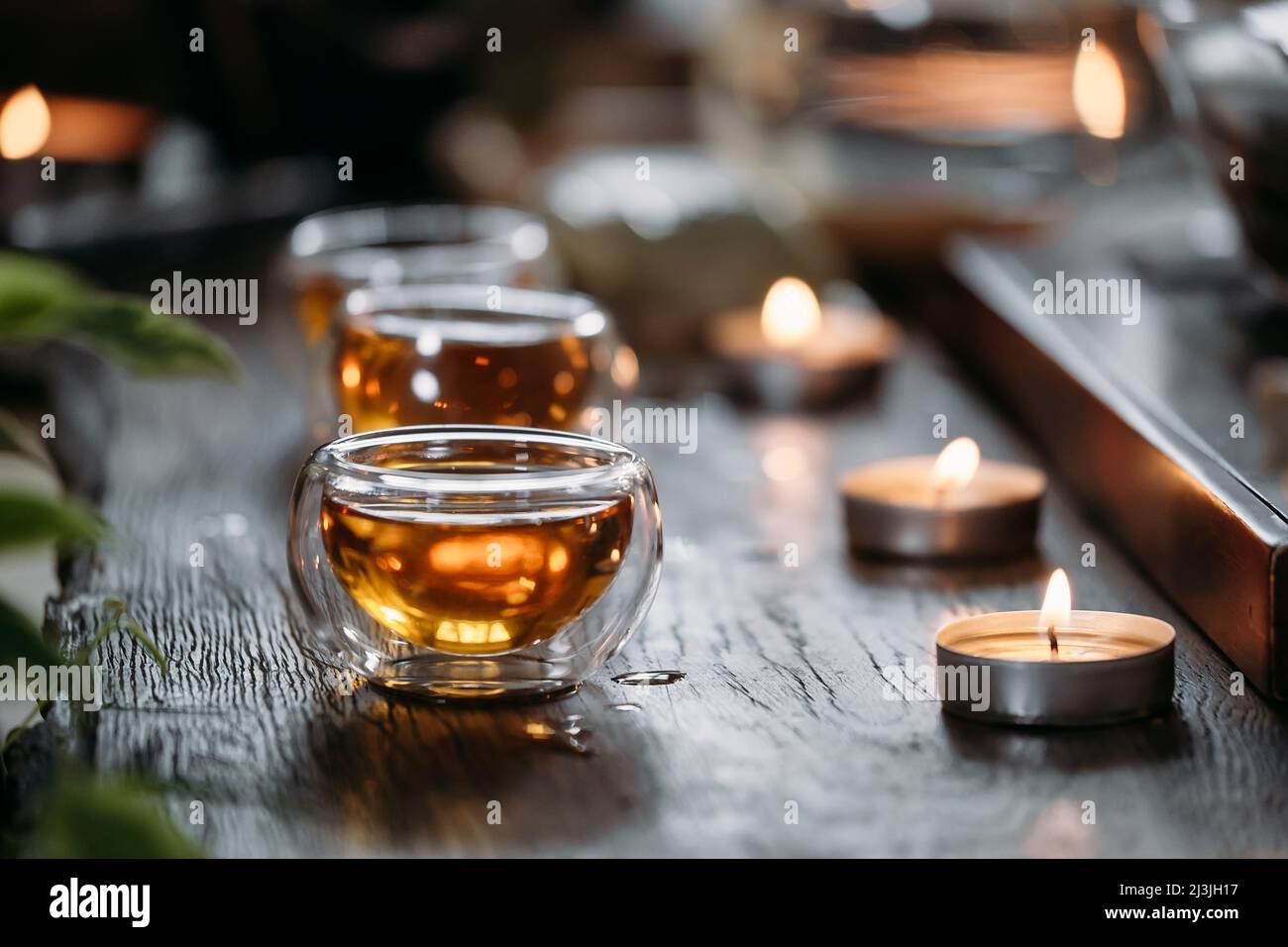 Chinese tea ceremony with candle flame decoration on a dark background ...