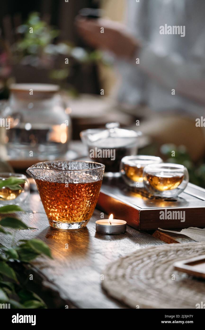 Chinese tea ceremony with candle flame decoration on a dark background ...