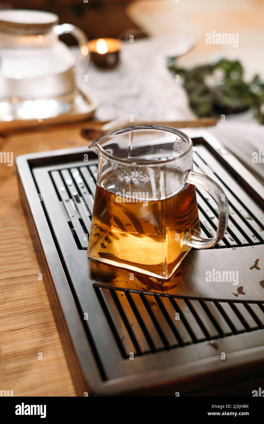 Traditional Chinese tea ceremony and pouring oolong from a teapot with ...