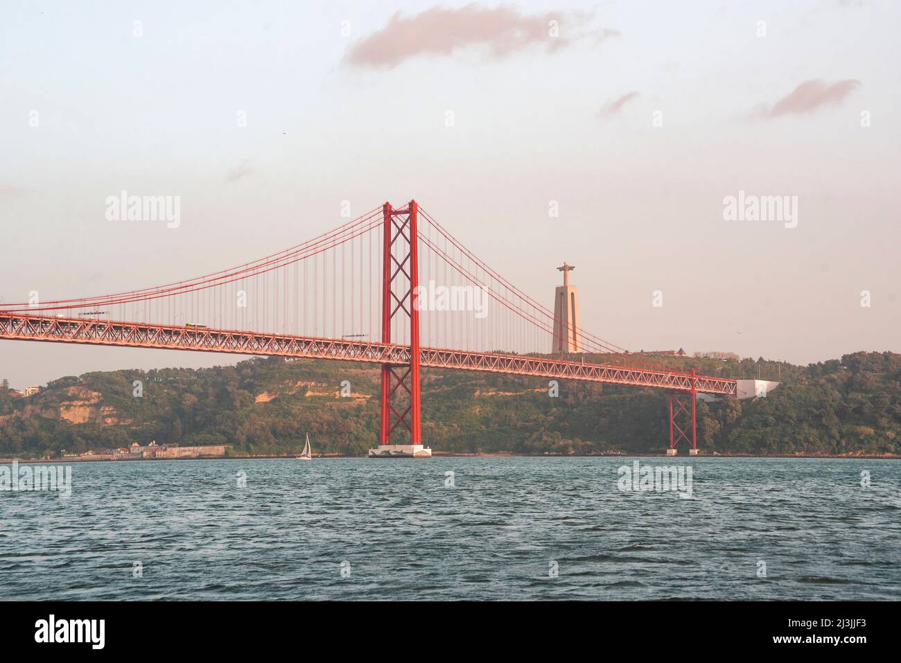 The 25 de Abril Bridge supension bridge of Lisbon at Sunset. Beautiful ...