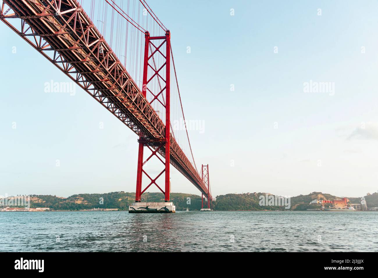 The 25 de Abril Bridge supension bridge of Lisbon at Sunset. Beautiful ...