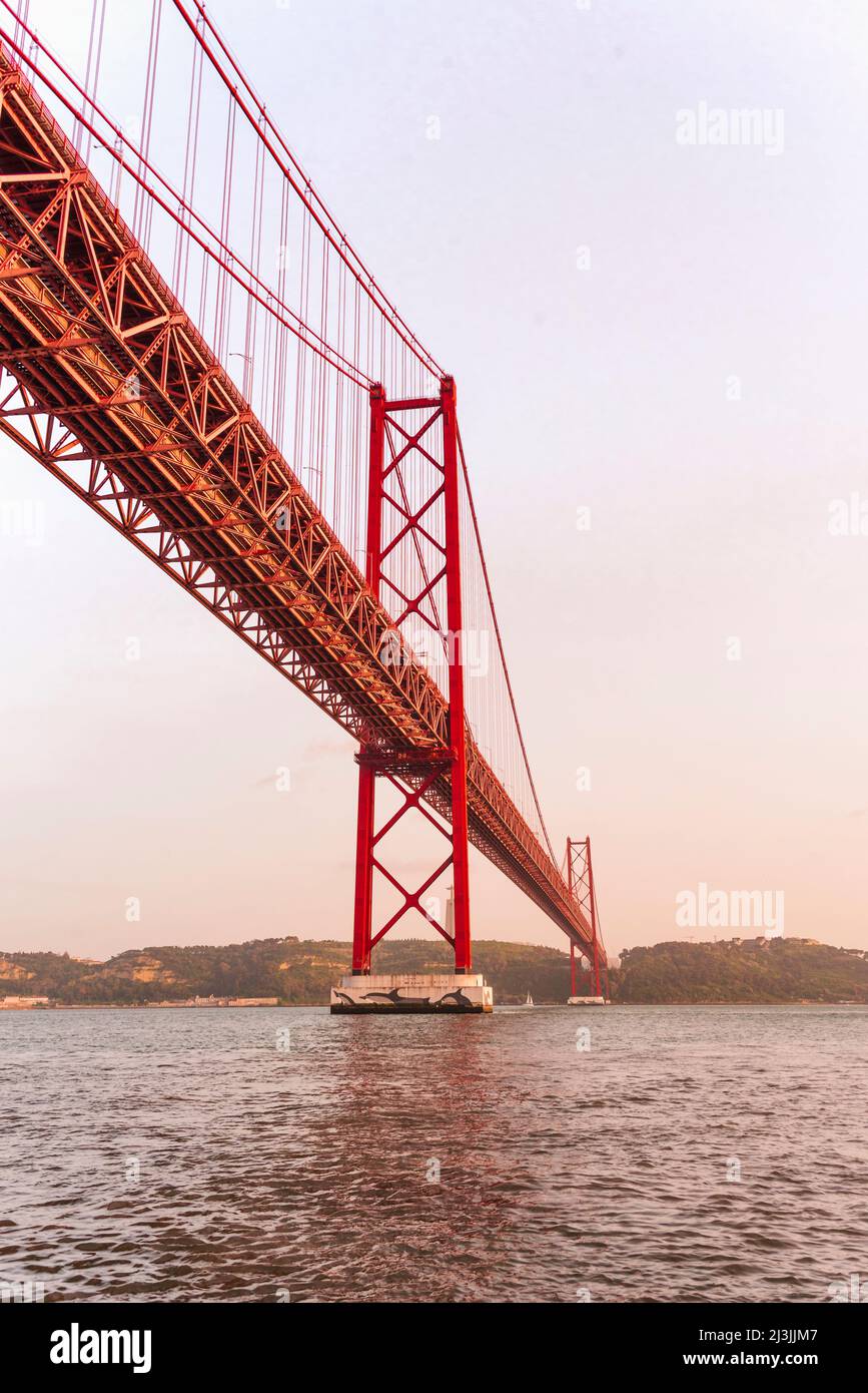 The 25 de Abril Bridge supension bridge of Lisbon at Sunset. Beautiful ...