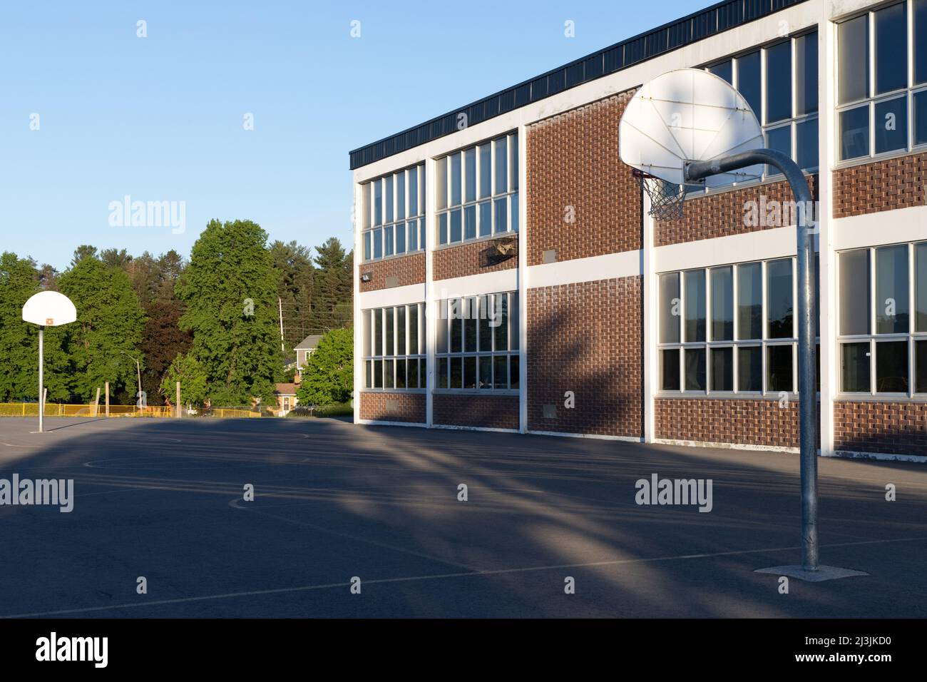 School building exterior and school yard with basketball court Stock ...