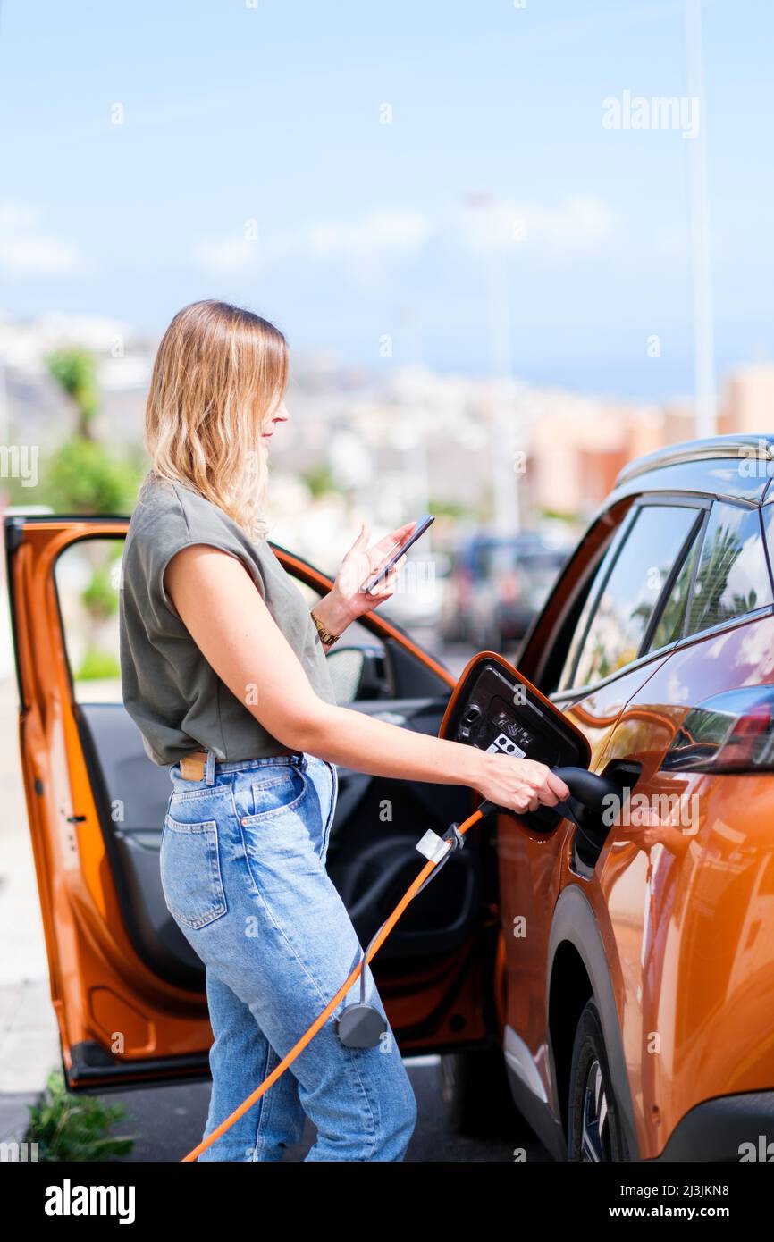 controlling with smartphone the connection of electric car Stock Photo ...