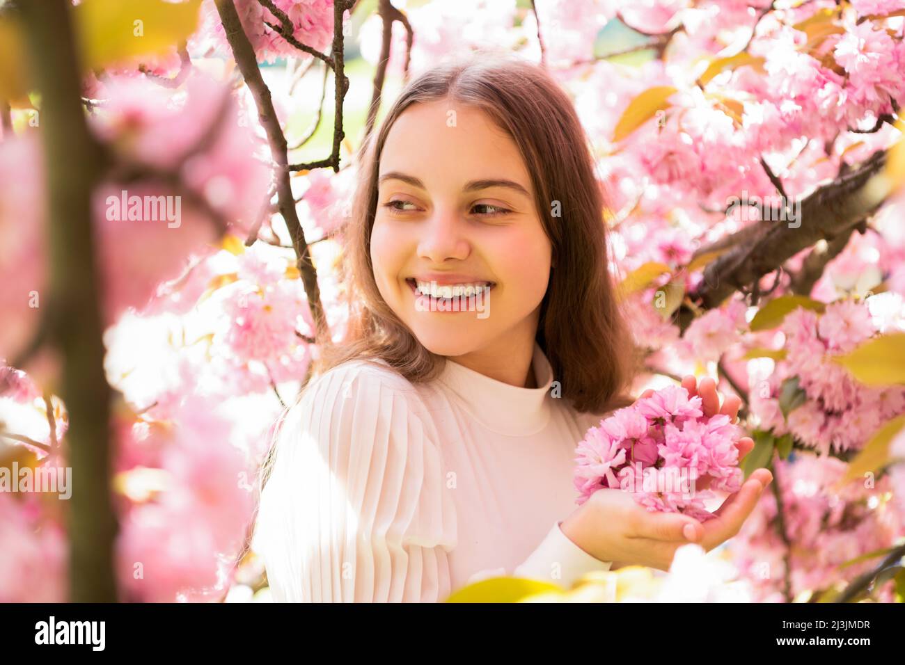 happy teen girl at sakura flower bloom in spring Stock Photo - Alamy