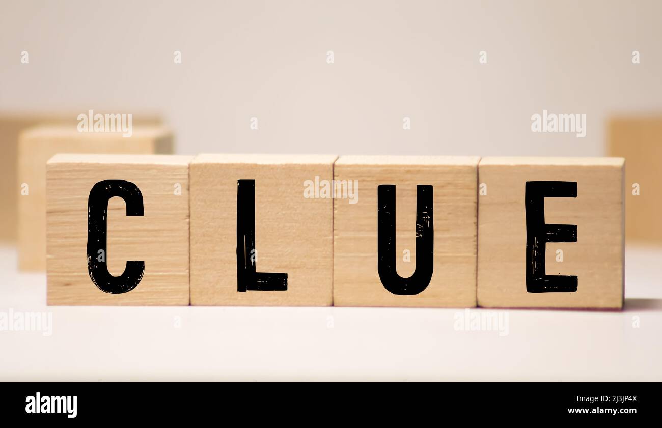 Clue word from wooden blocks on desk Stock Photo - Alamy