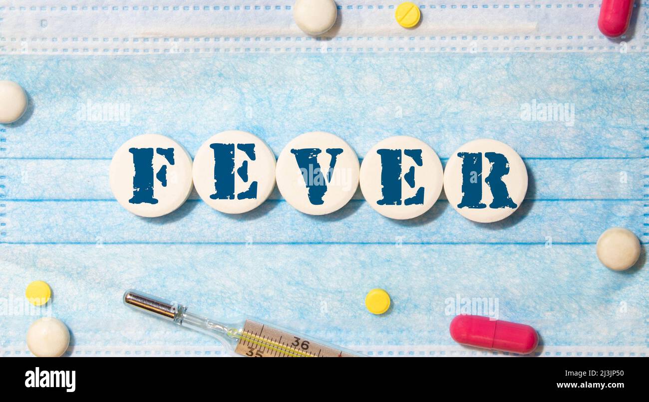 Fever, word cube with background. medical concept Stock Photo - Alamy