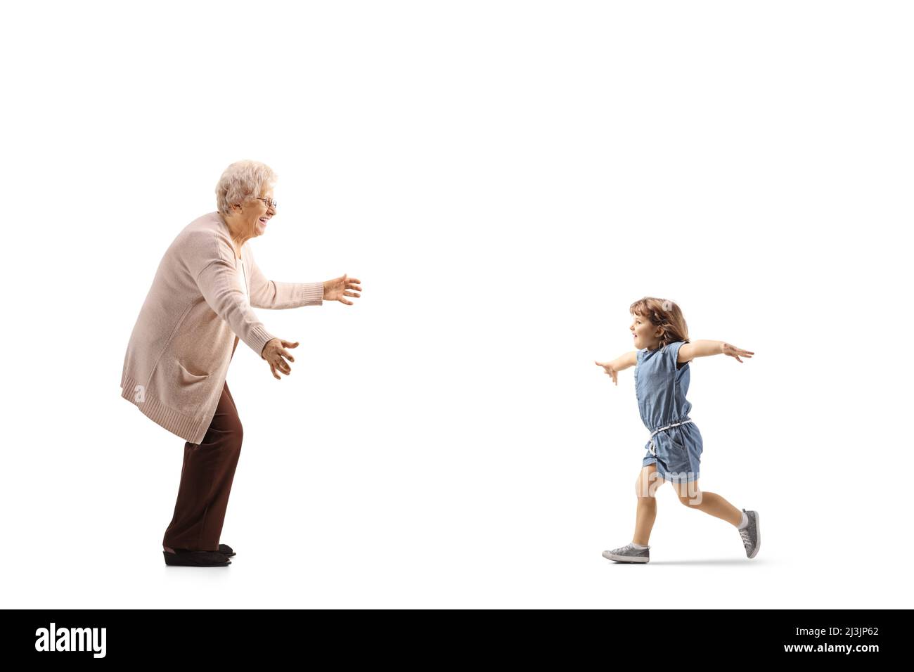 Full length profile shot of a child running towards grandmother with ...