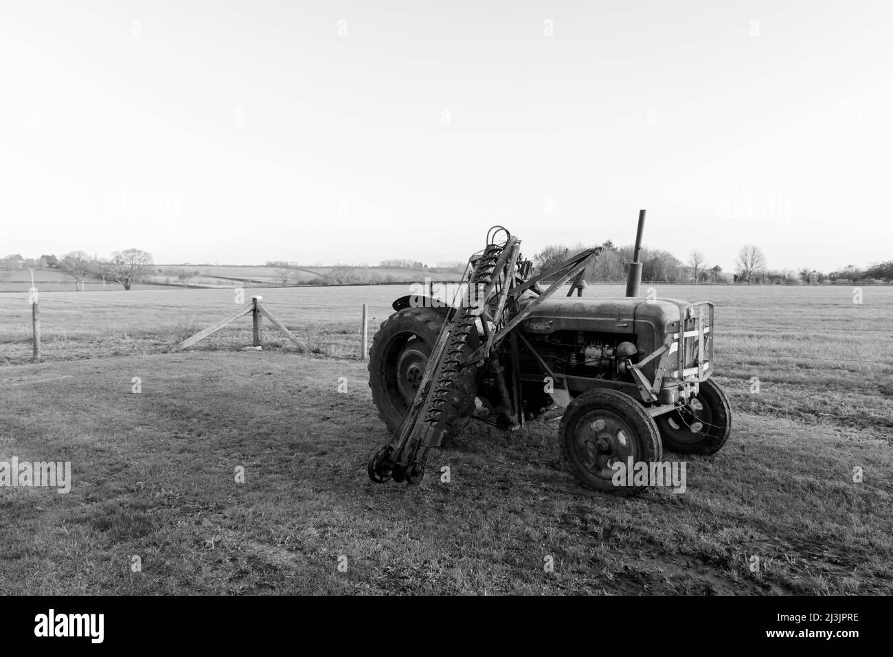 An old antique hedge trimmer mounted on a vintage tractor Stock Photo ...