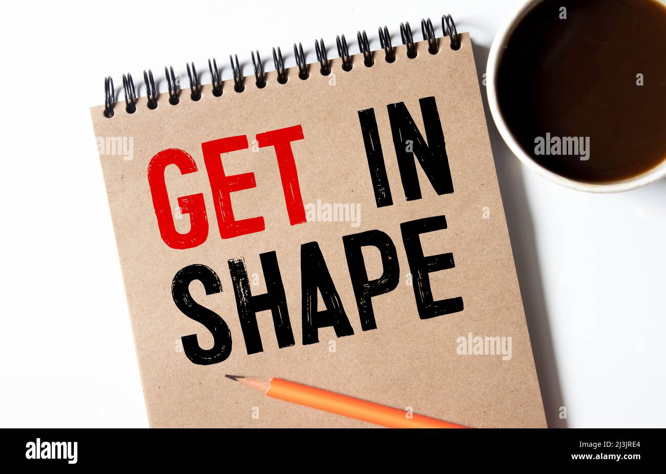 Get in shape - handwriting on notepad with dumbbell, green apple and ...