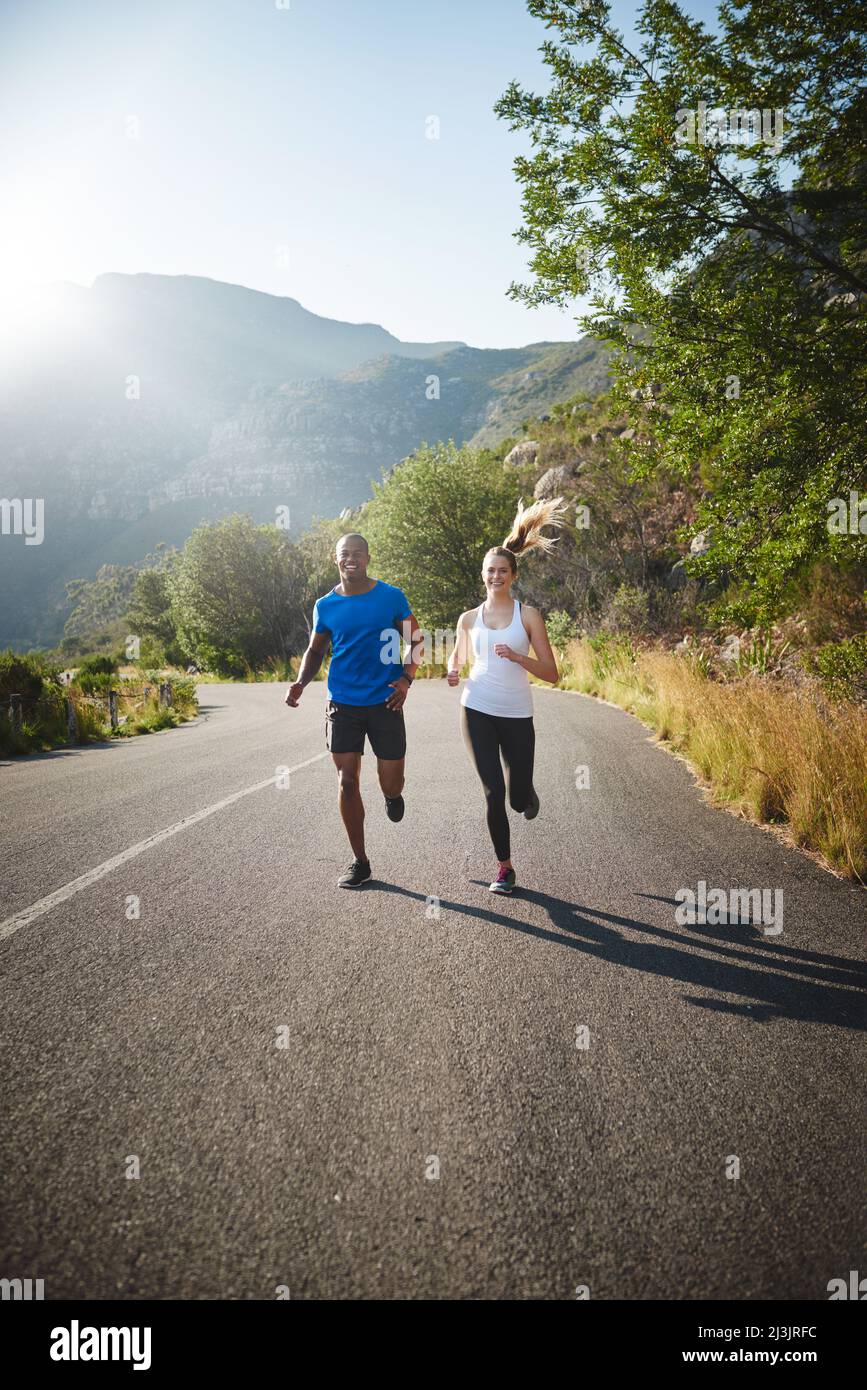 Were in it for the long run. Shot of a sporty couple out running on a ...