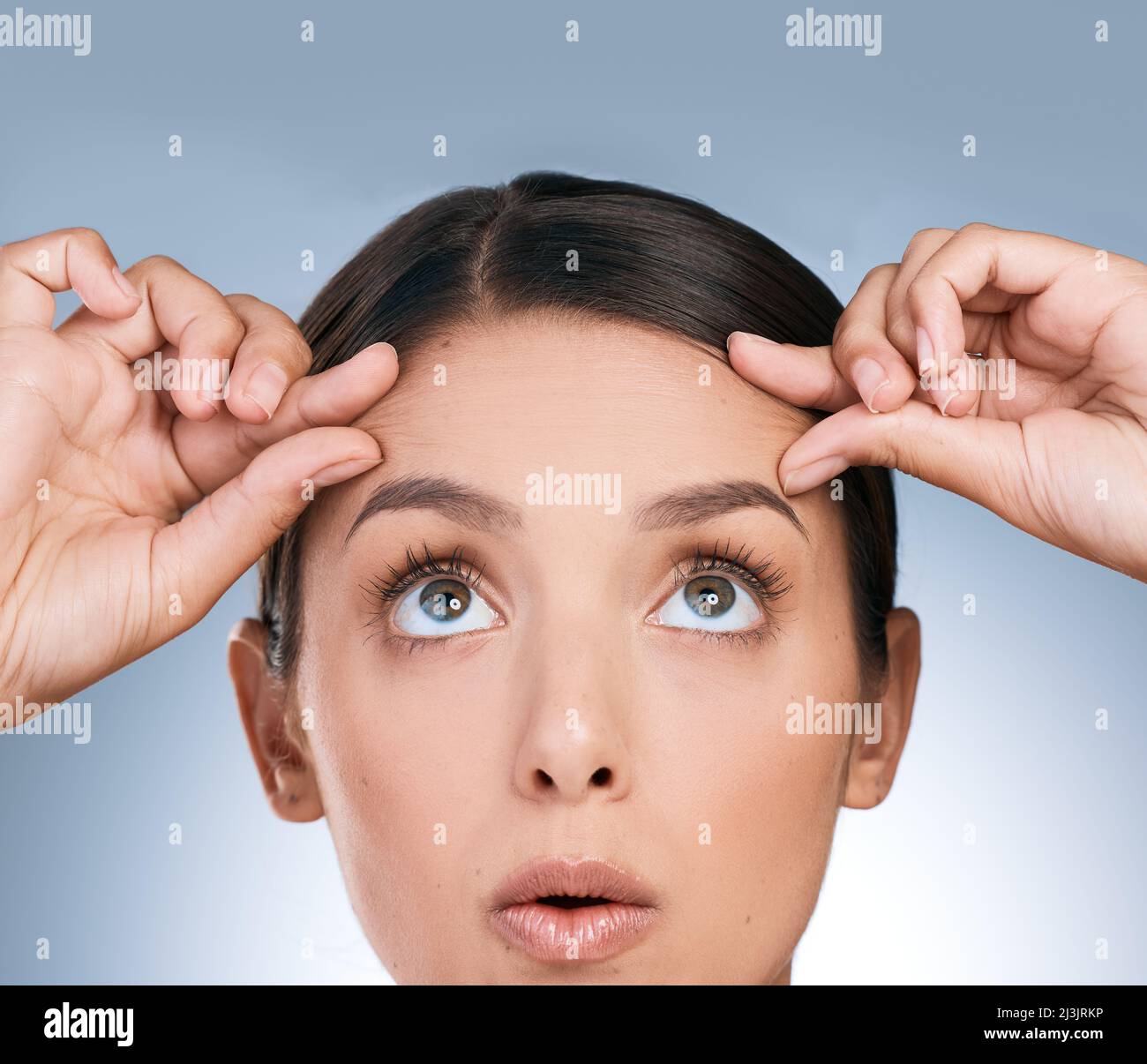 Woman touching forehead checking hi-res stock photography and images ...