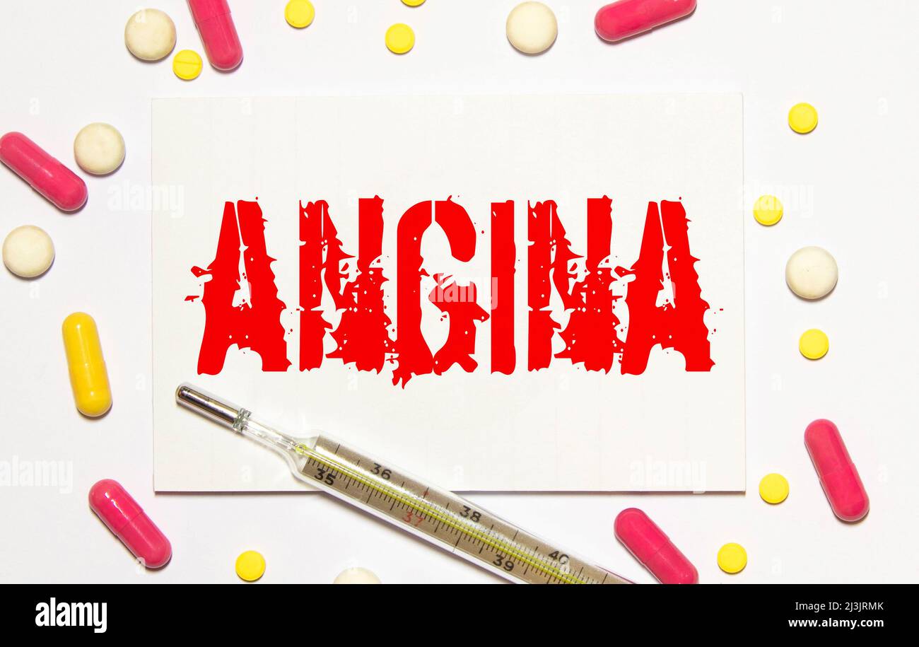 Angina word written on medical blue folder with patient files, pills ...