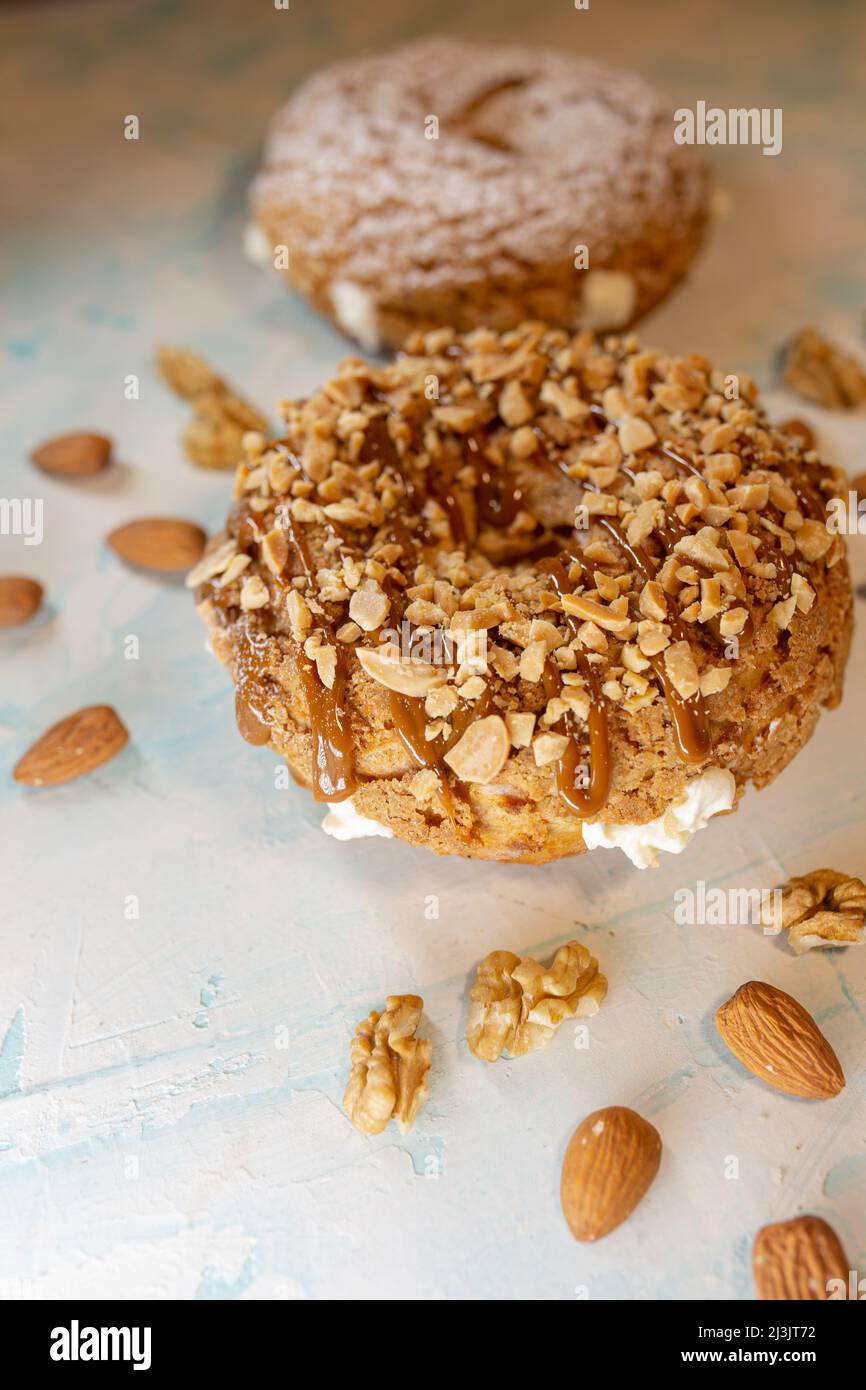 A piece of delicious handmade donut with nuts Stock Photo - Alamy
