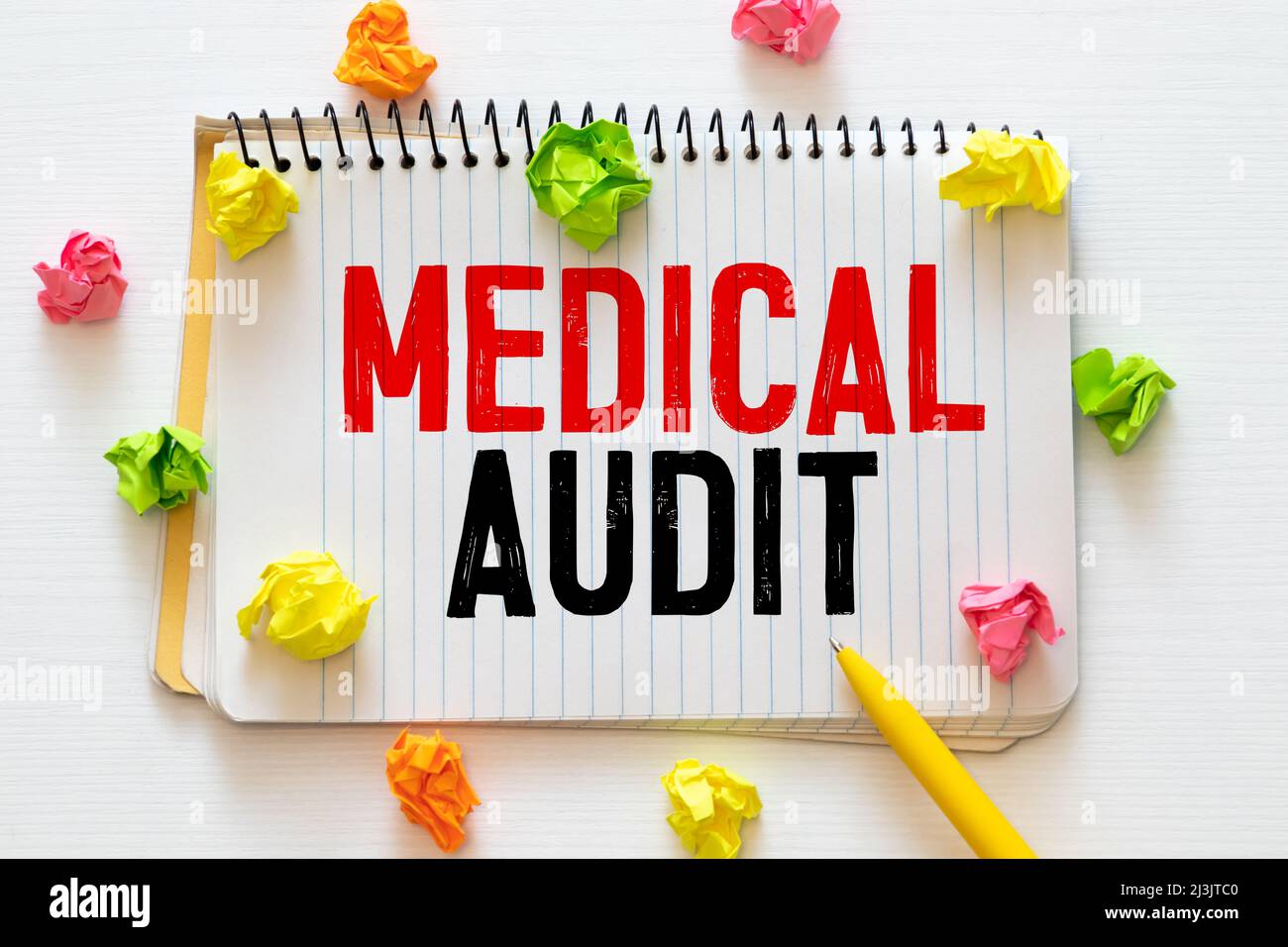 Doctor holding a business card with capital lettering MEDICAL AUDIT in ...