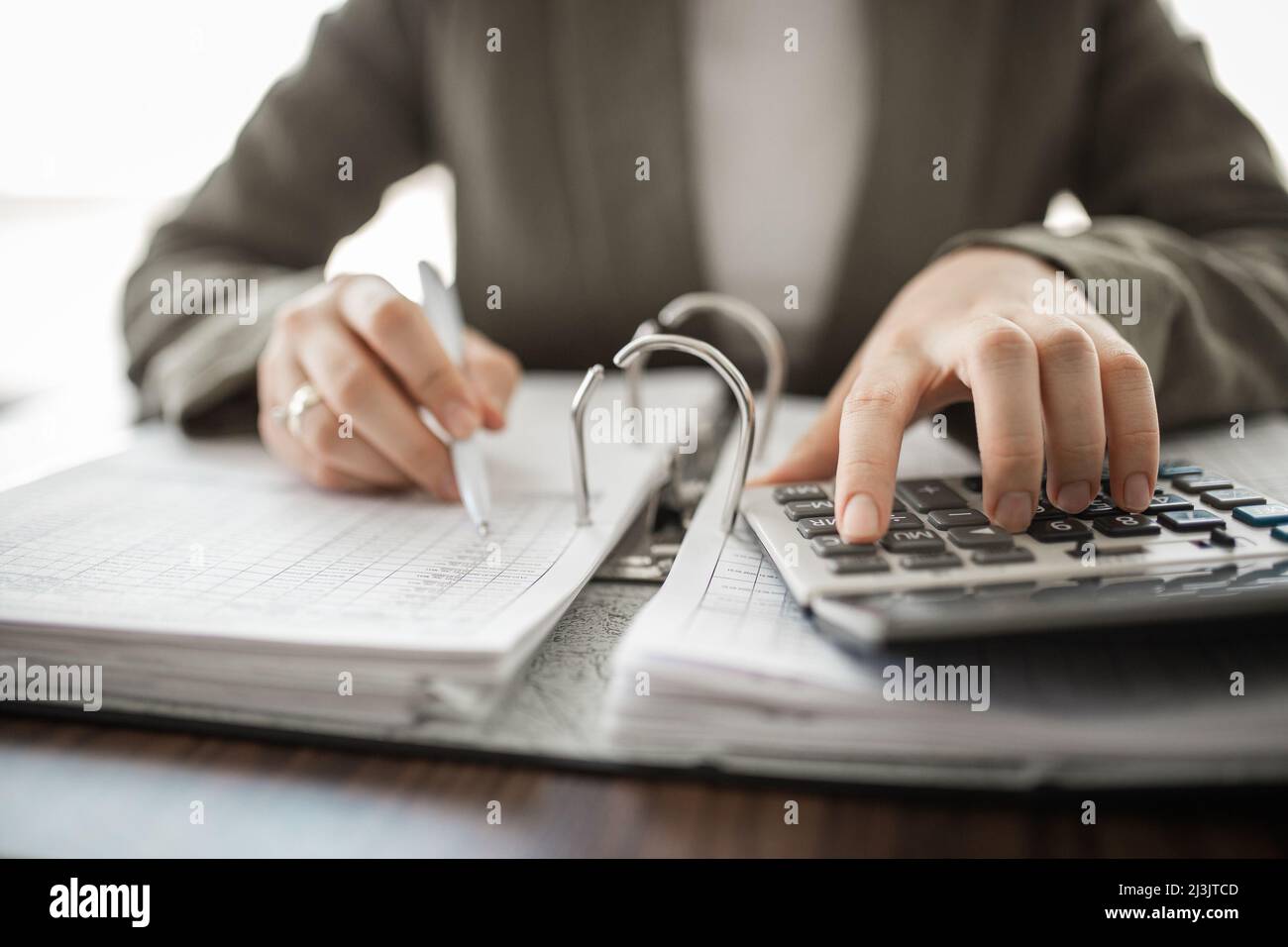 Close-up of businessman hand calculating invoice with calculator Stock ... Close-up of businessman hand calculating invoice with calculator Stock ...