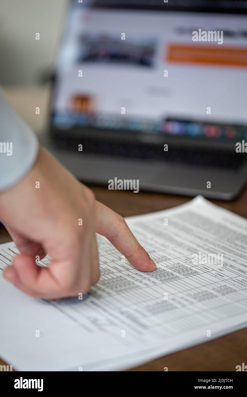 a man checks documents with his finger Stock Photo - Alamy