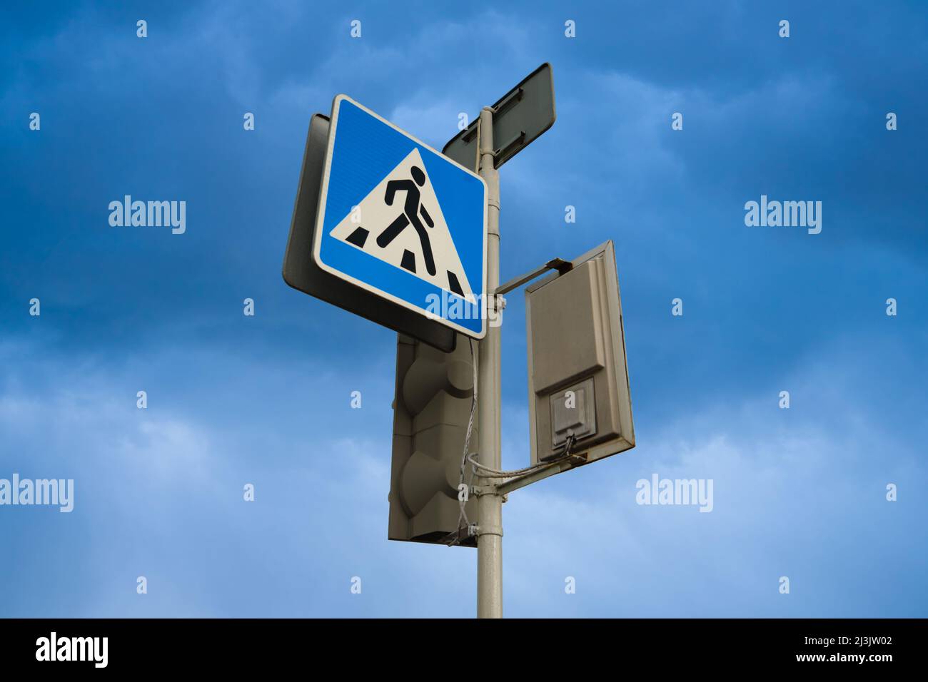 Crosswalk road sign against the backdrop of a blue sky. Pedestrian ...