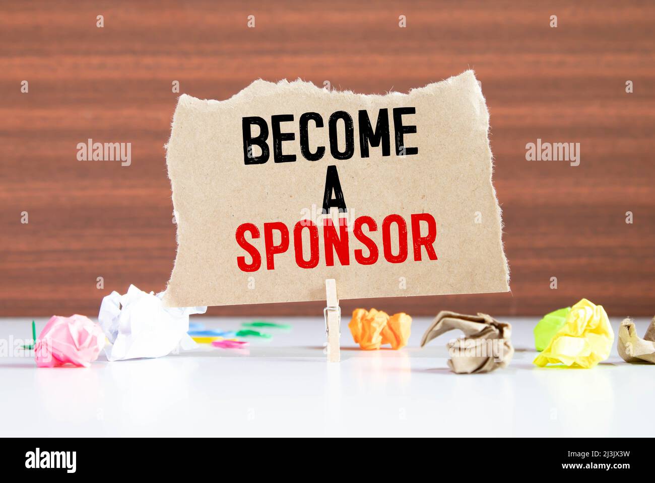 Become a Sponsor written behind a torn paper Stock Photo - Alamy