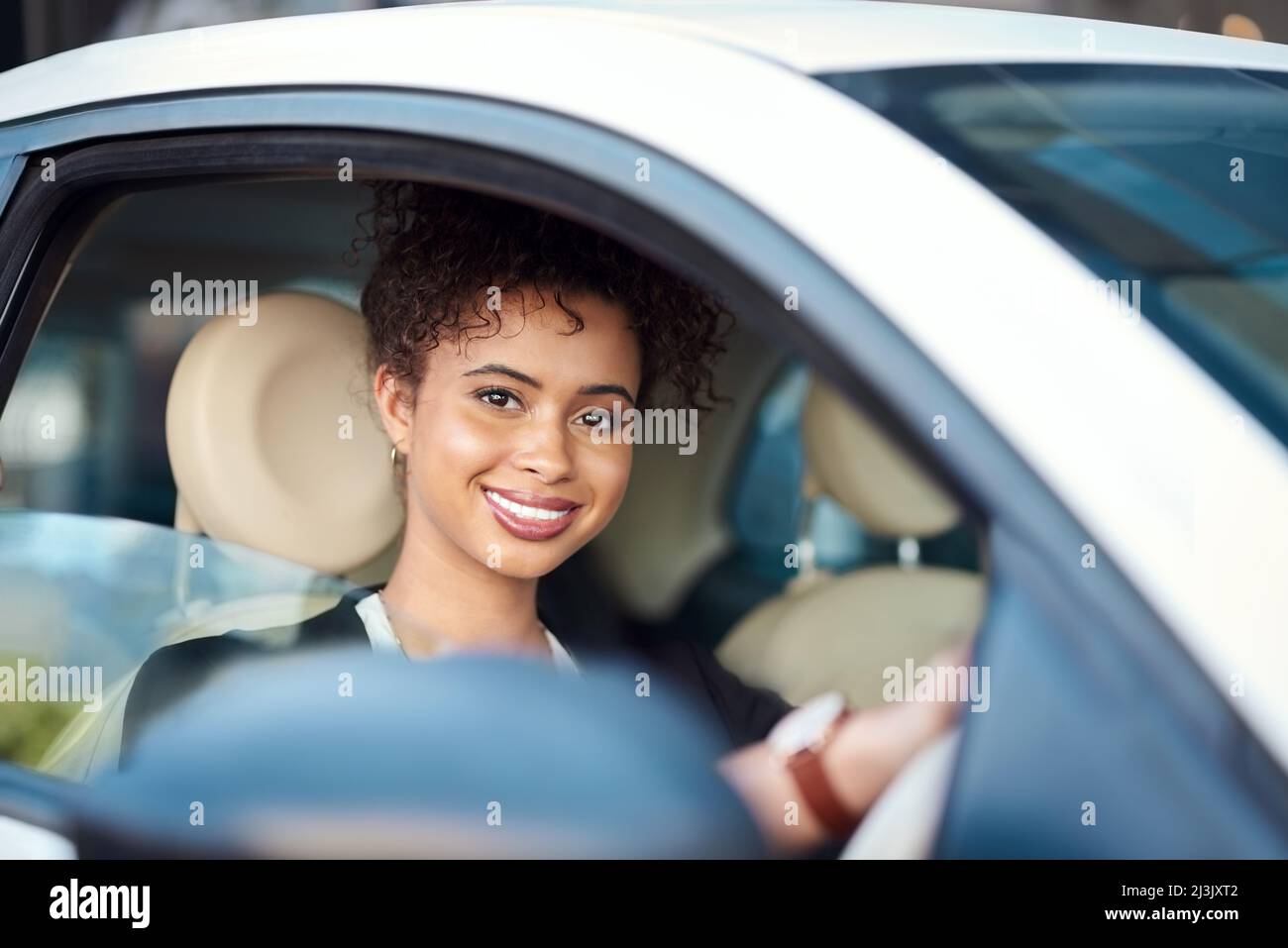 Feels good being on this side of the car. Cropped portrait of an ...
