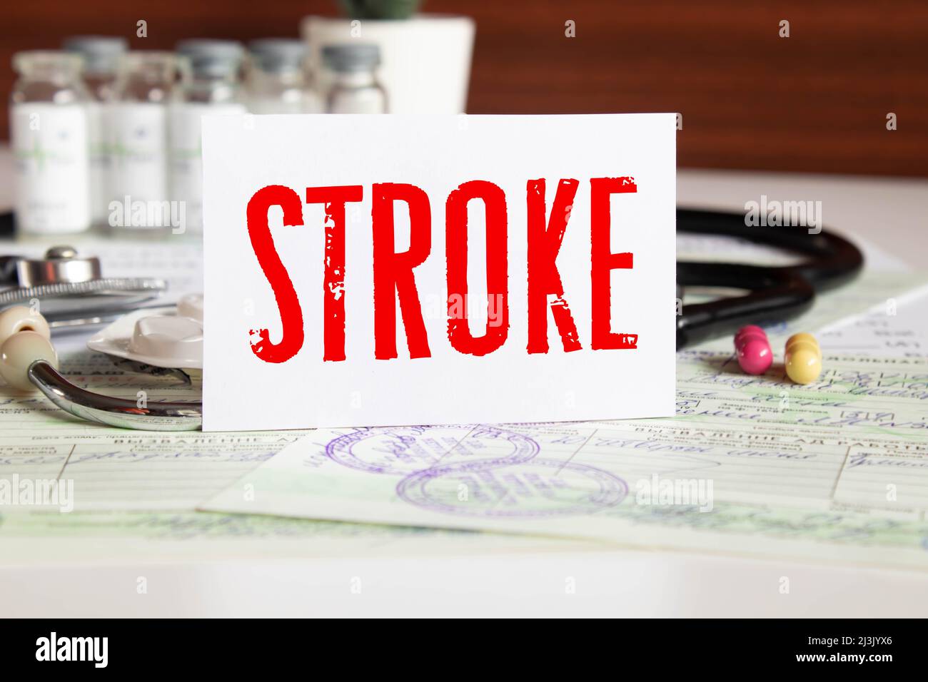 Hand in blue glove with white card. Concept word stroke Stock Photo - Alamy