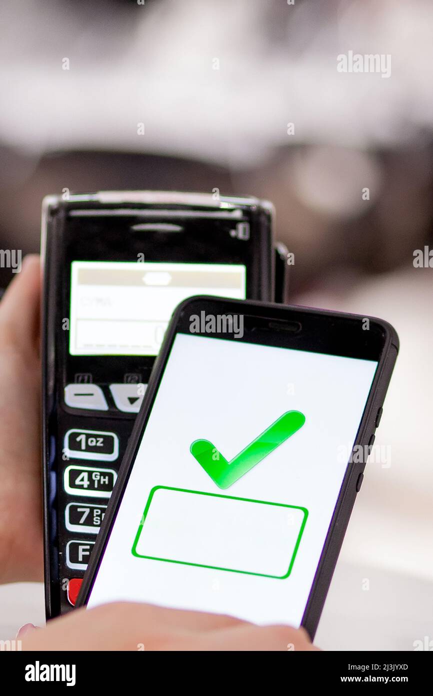 POS terminal, Payment Machine with mobile phone on store background ...