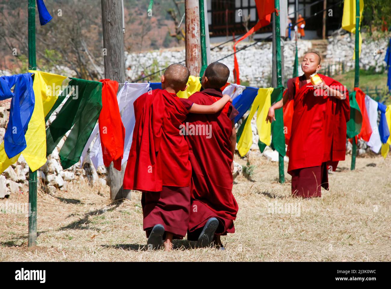 Two young monks walk together during the Bhutanese Paro Tshechu ...