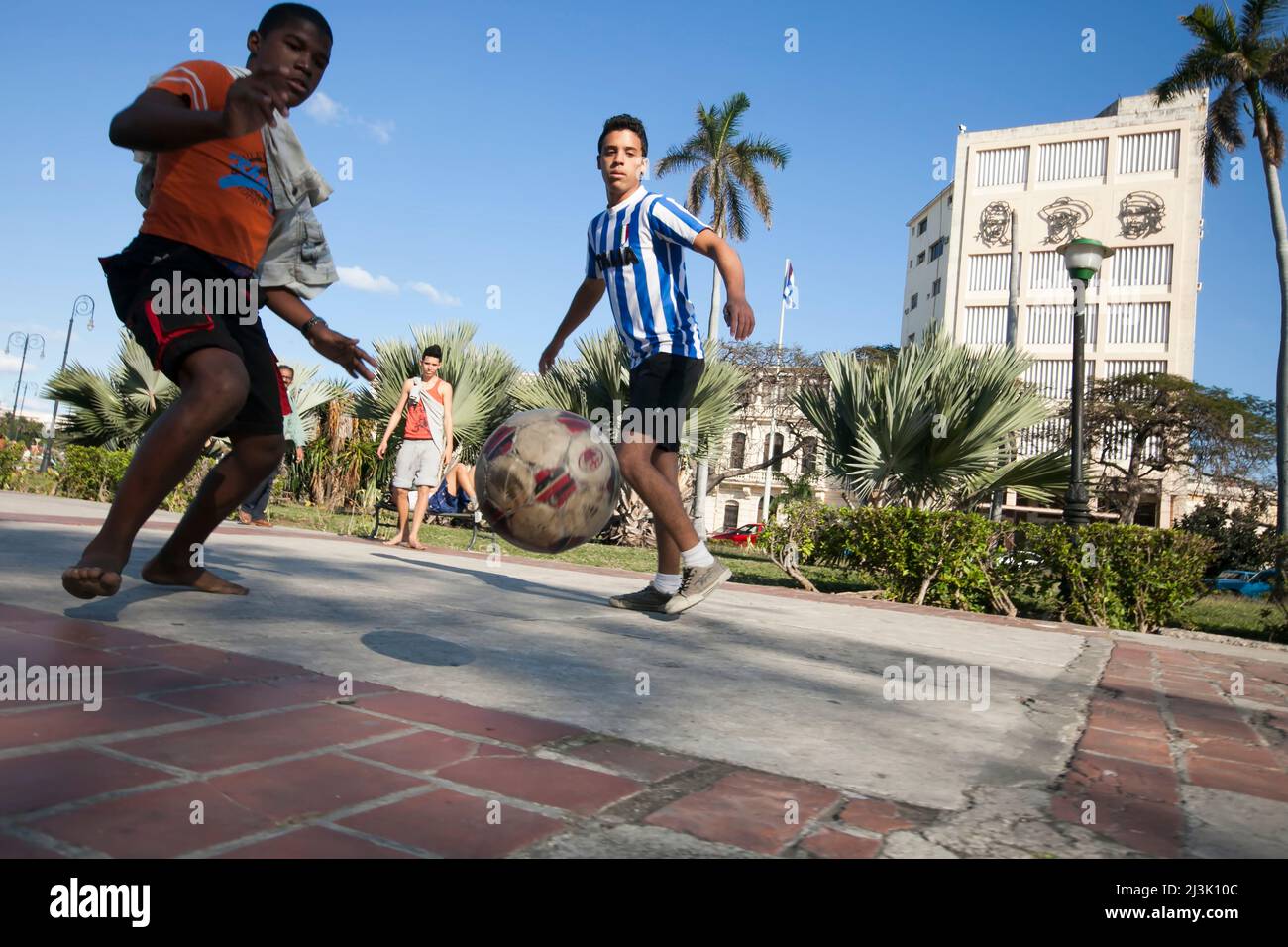Several boys play soccer (futbol, football) on a street in Havana, Cuba ...
