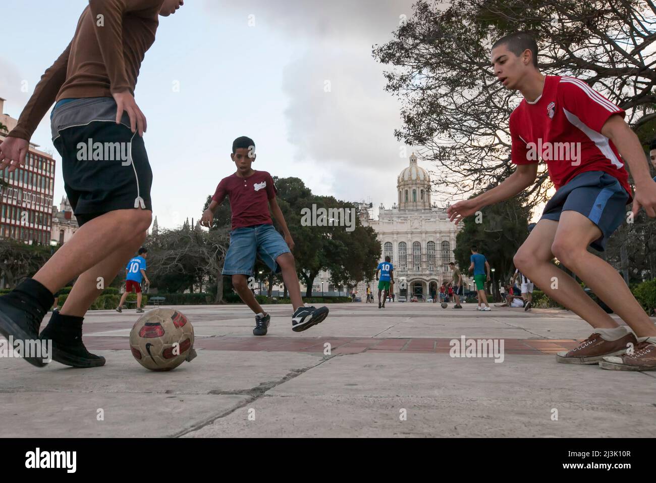 Several boys play soccer (futbol, football) on a street in Havana, Cuba ...