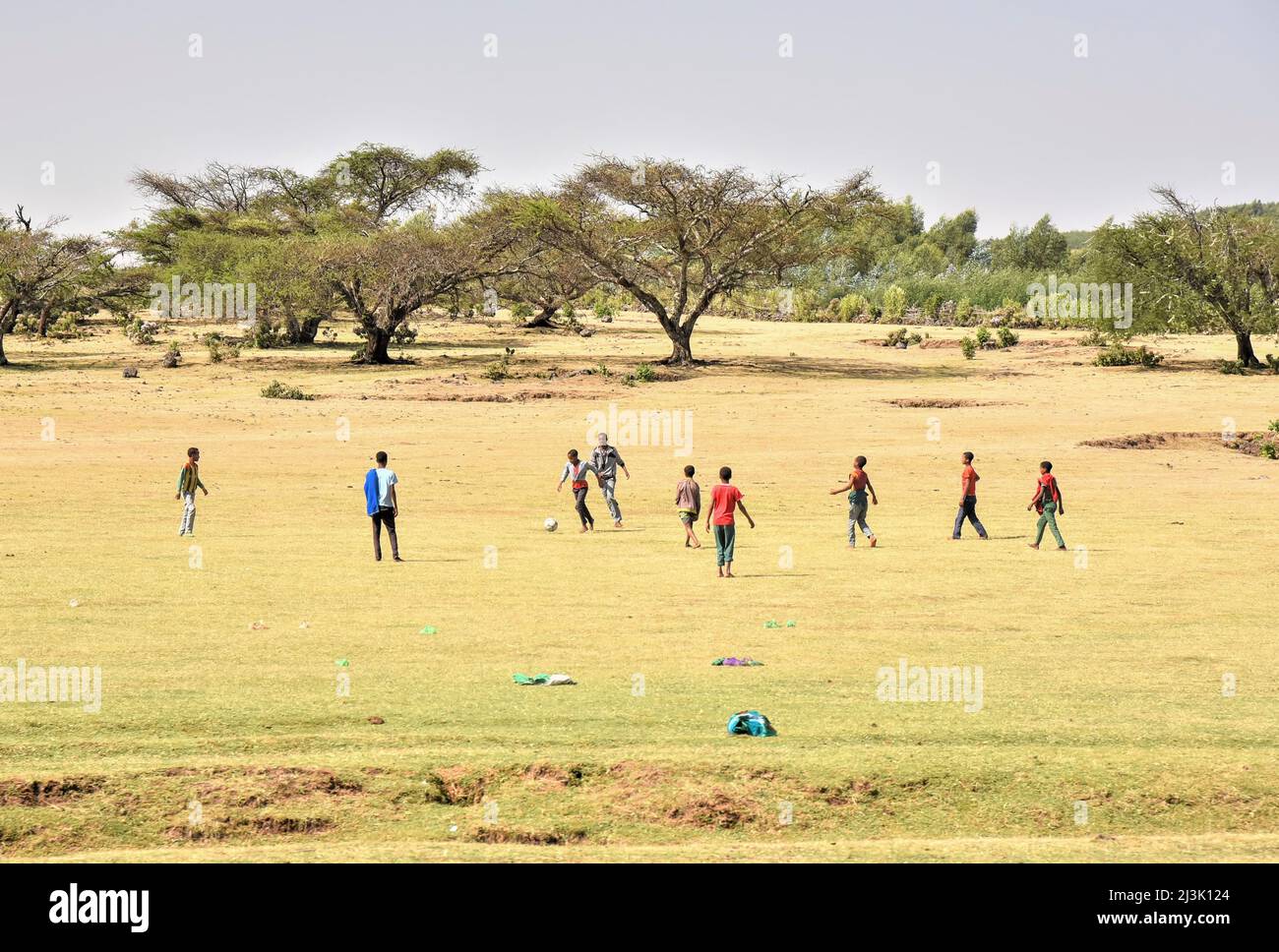 Children playing soccer on a grass field in rural Ethiopia; Ethiopia ...