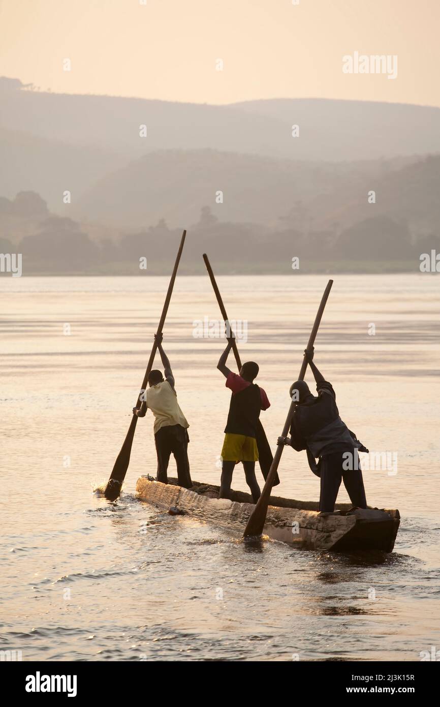 Young Congolese fisherman paddle their pirogue across the Zaire River ...