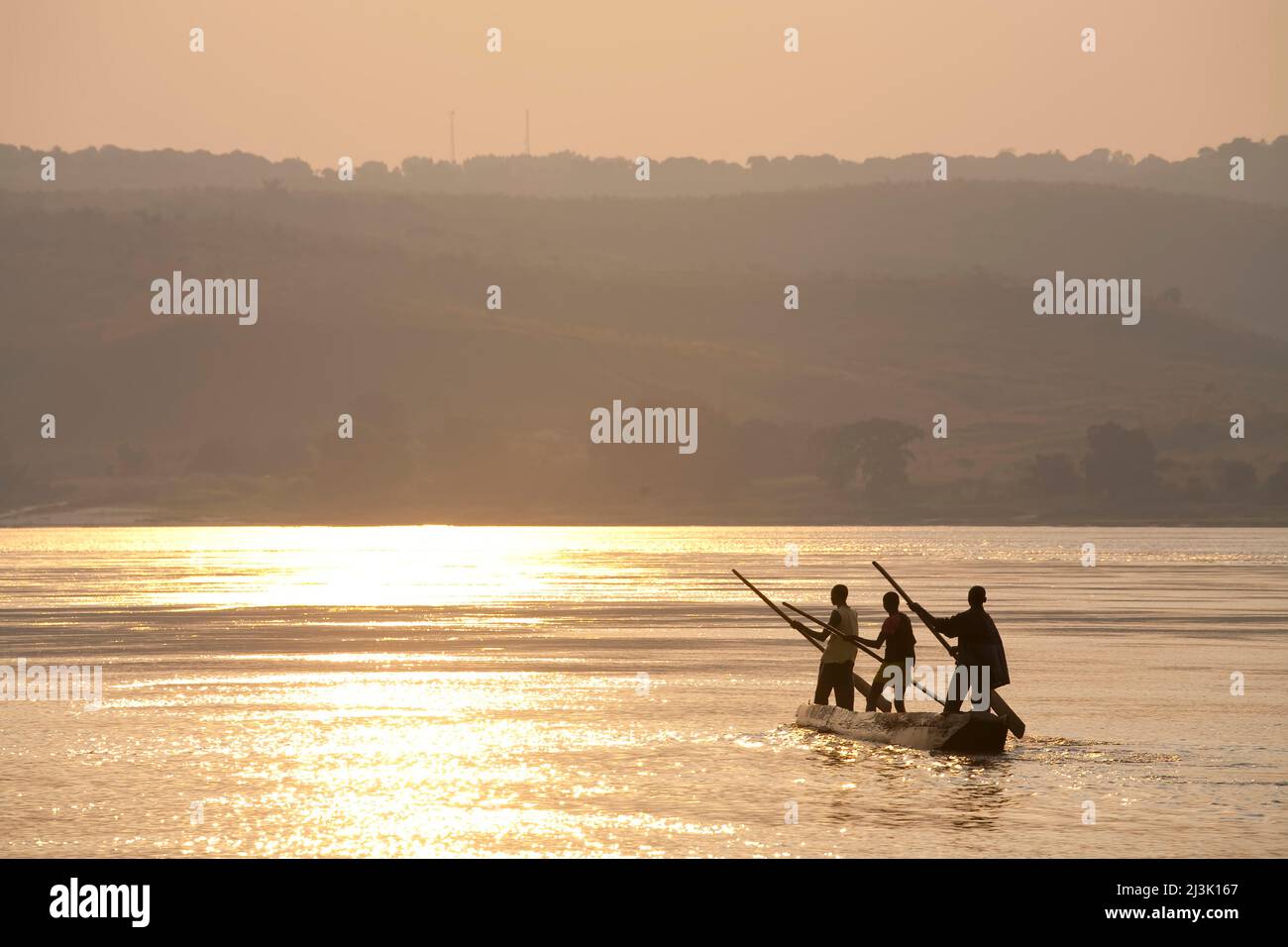 Young Congolese fisherman paddle their pirogue across the Congo River ...