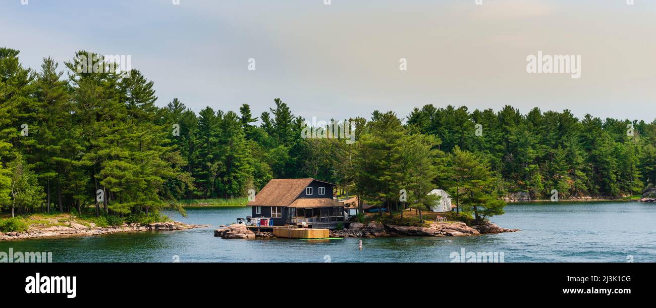 Small island with a house and dock in the Thousand Islands; Ontario ...