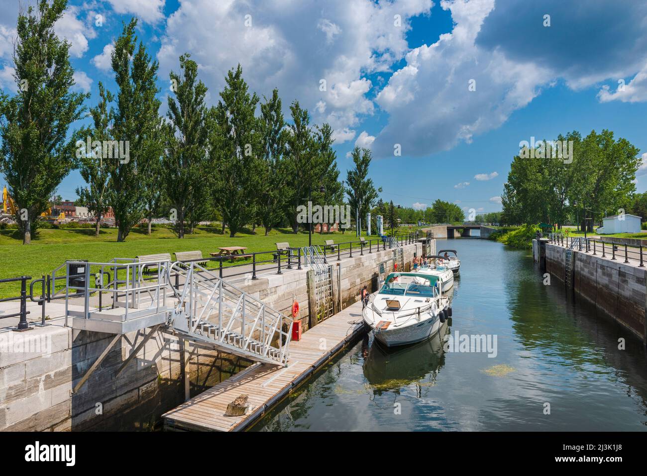 Boats in Lachine Canal and a bridge crossing; Montreal, Quebec, Canada ...