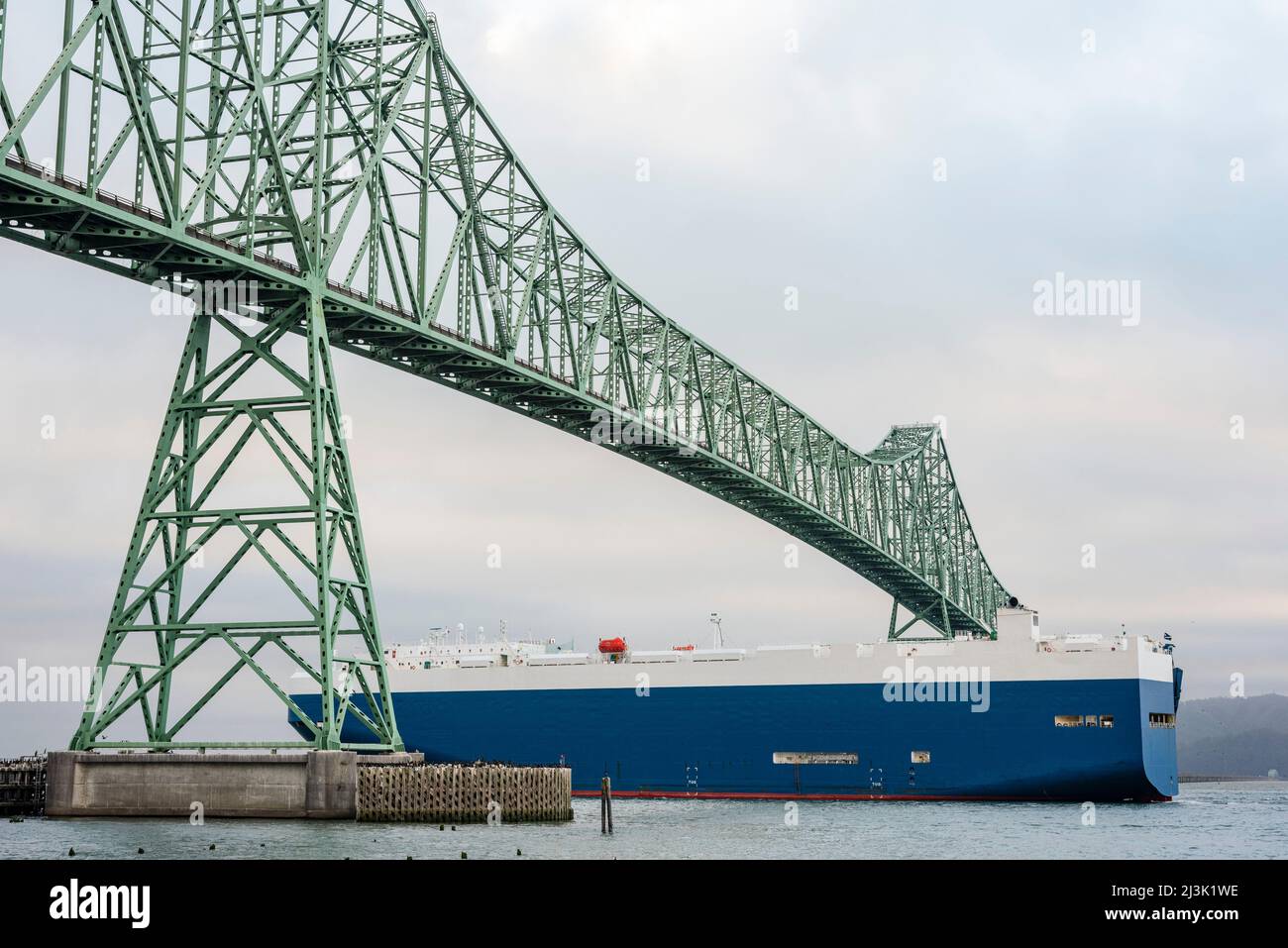 A car carrier ship passes beneath the Astoria-Megler bridge at Astoria ...