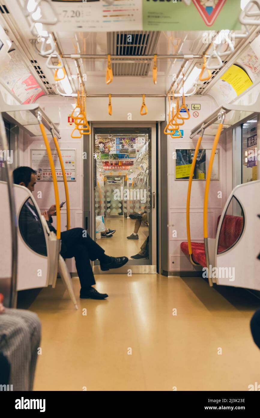 Passengers riding on the modern subway train in Tokyo; Tokyo, Japan ...