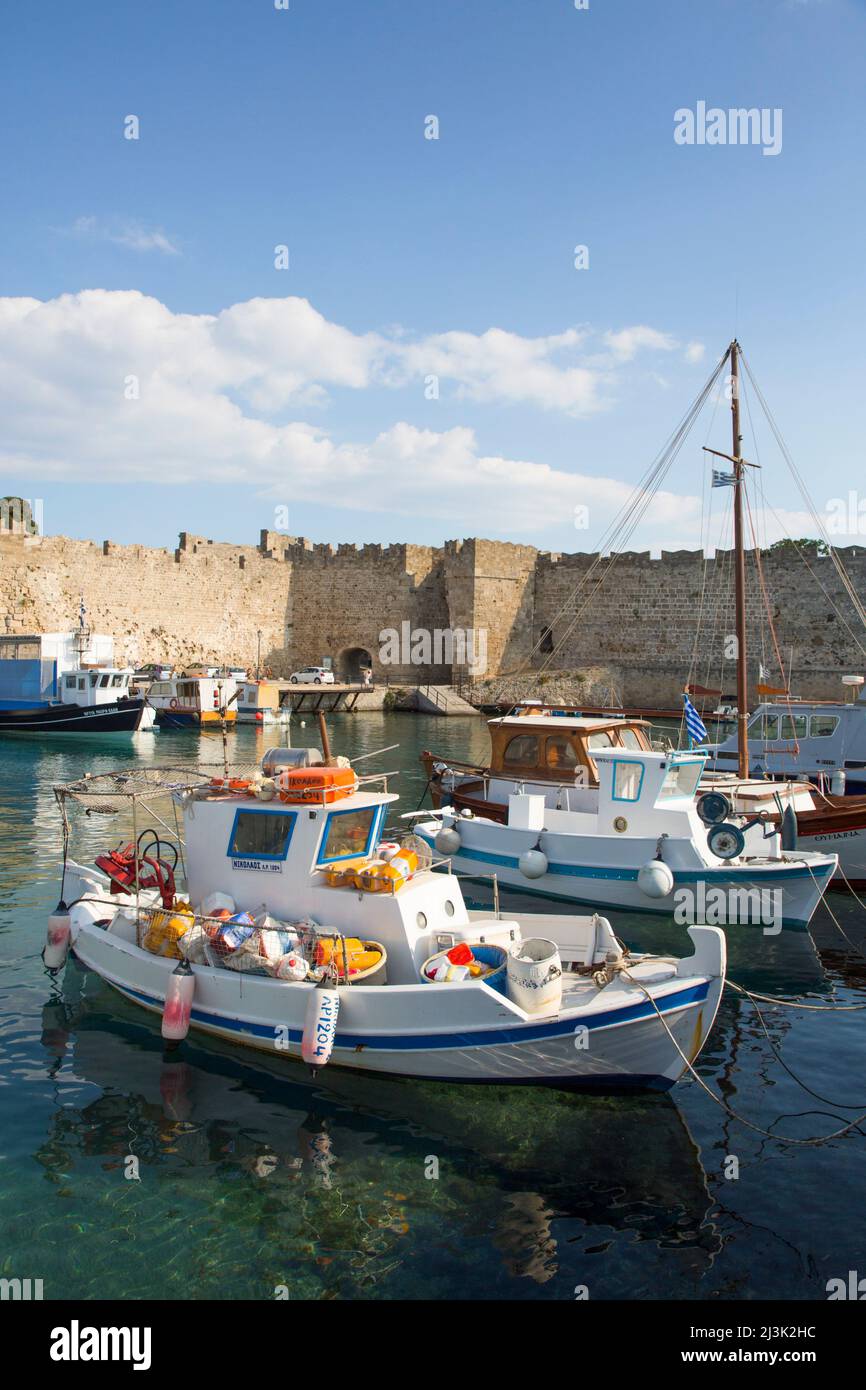 Fishing boats moored in Kolona Harbour in the medieval city of Rhodes ...