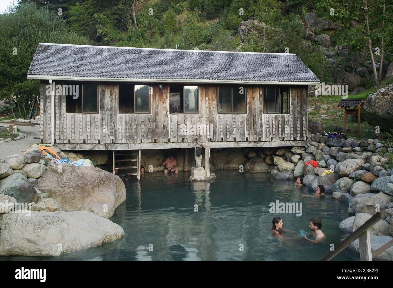 People bathing in a natural hot spring, in Patagonia, Chile.; Pozones ...