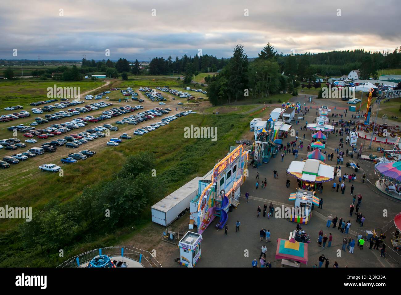 In Astoria, Oregon, a carnival and the parking lot is captured from an ...